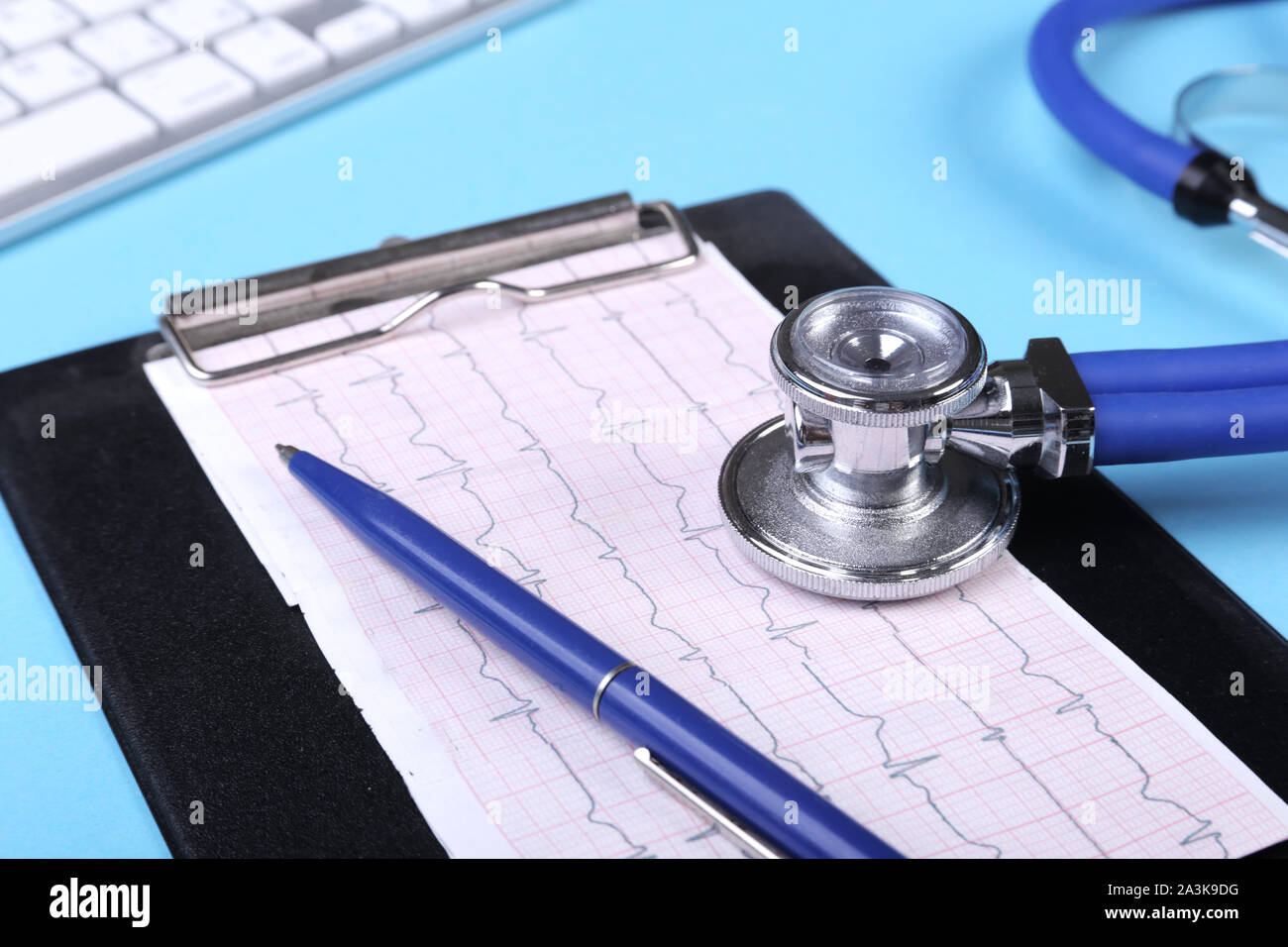 keyboard and Medical stethoscope lying on cardiogram chart closeup ...