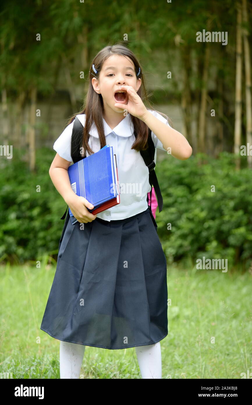 Pretty Minority Child Girl Student Shouting With Books Stock Photo - Alamy