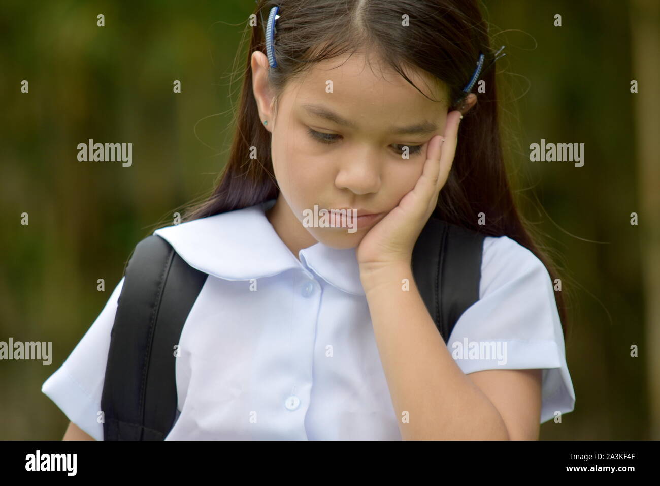 Young Filipina Female Student And Sadness With Books Stock Photo - Alamy