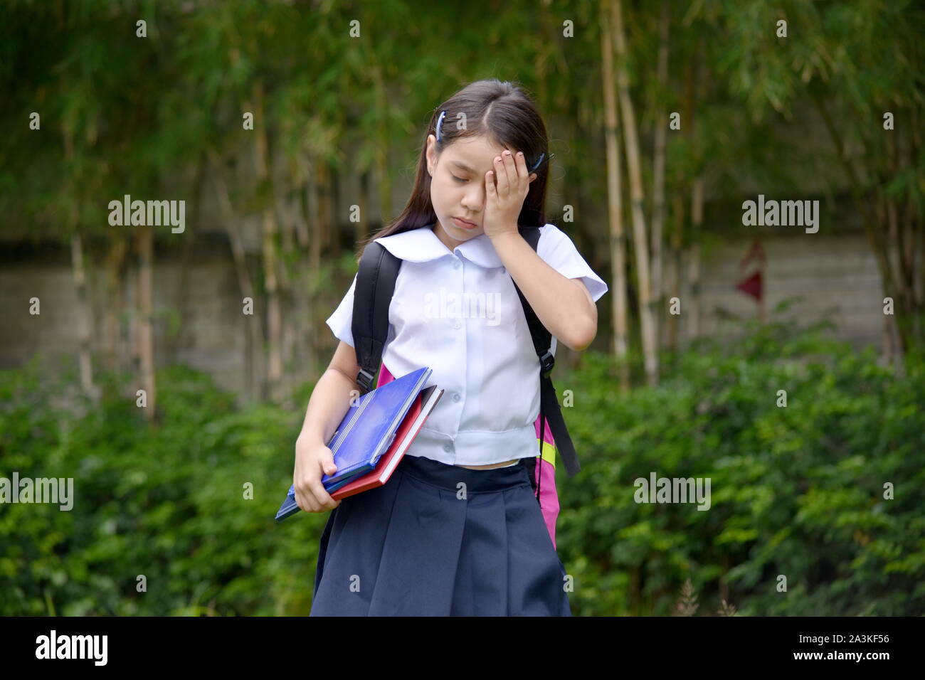 Sad Young Student Child With Notebooks Stock Photo - Alamy