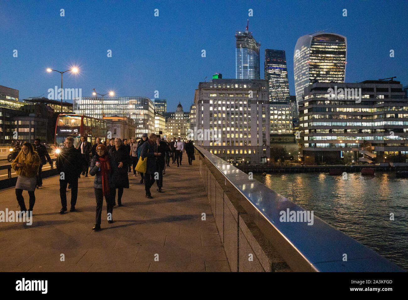 Commuters on London Bridge at dusk, with The Shard beyond, London ...