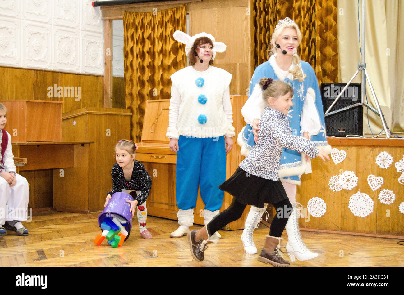 Children's Christmas New Year's concert. Children play with Snow Maiden ...
