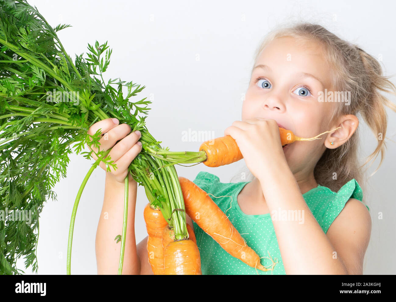 A child with a vegetable carrots Stock Photo - Alamy