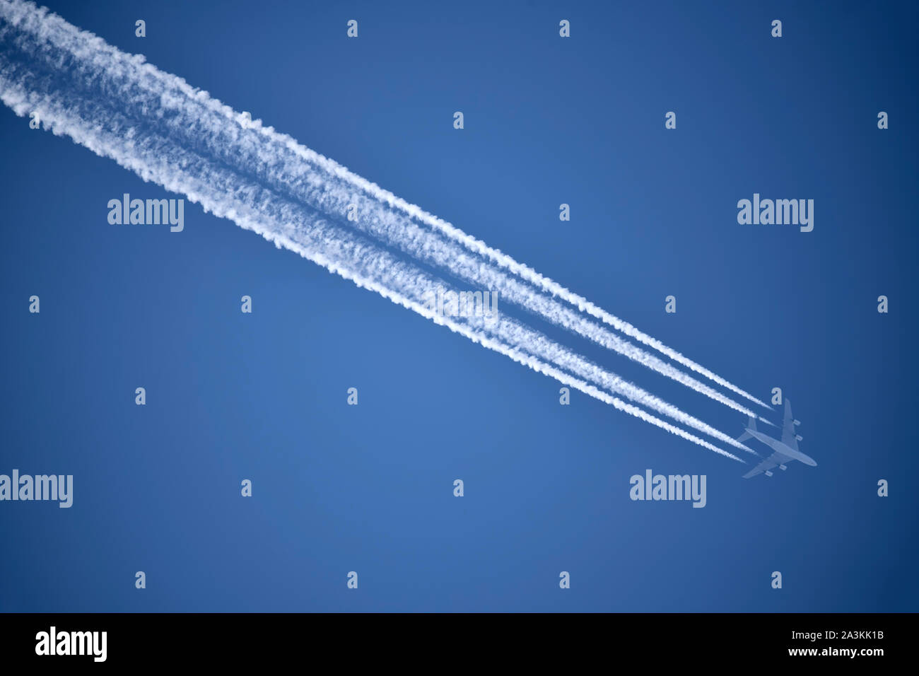 Aircraft with contrails Stock Photo - Alamy