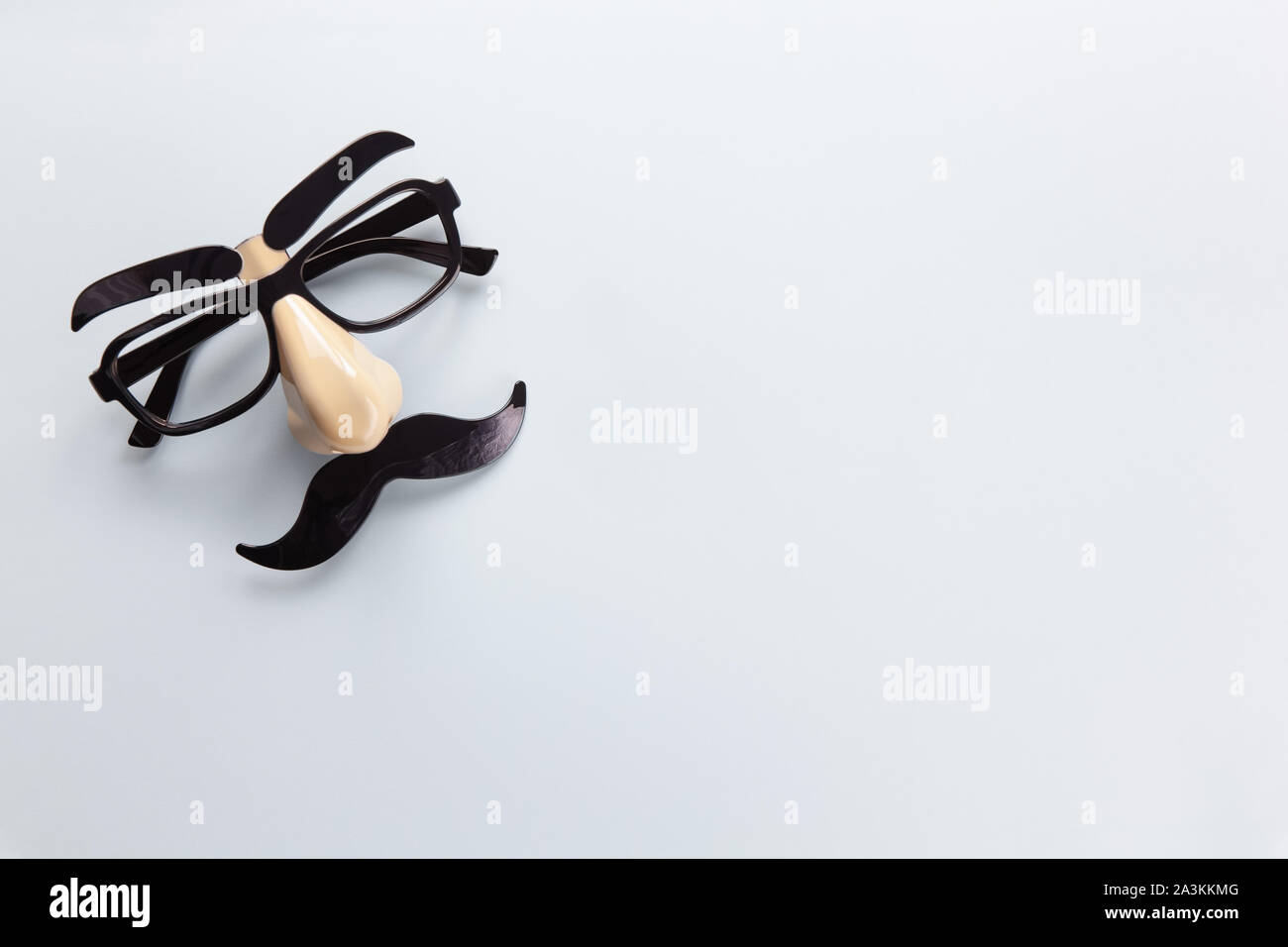 Carnival mask with moustache, nose and glasses on grey background, copy ...