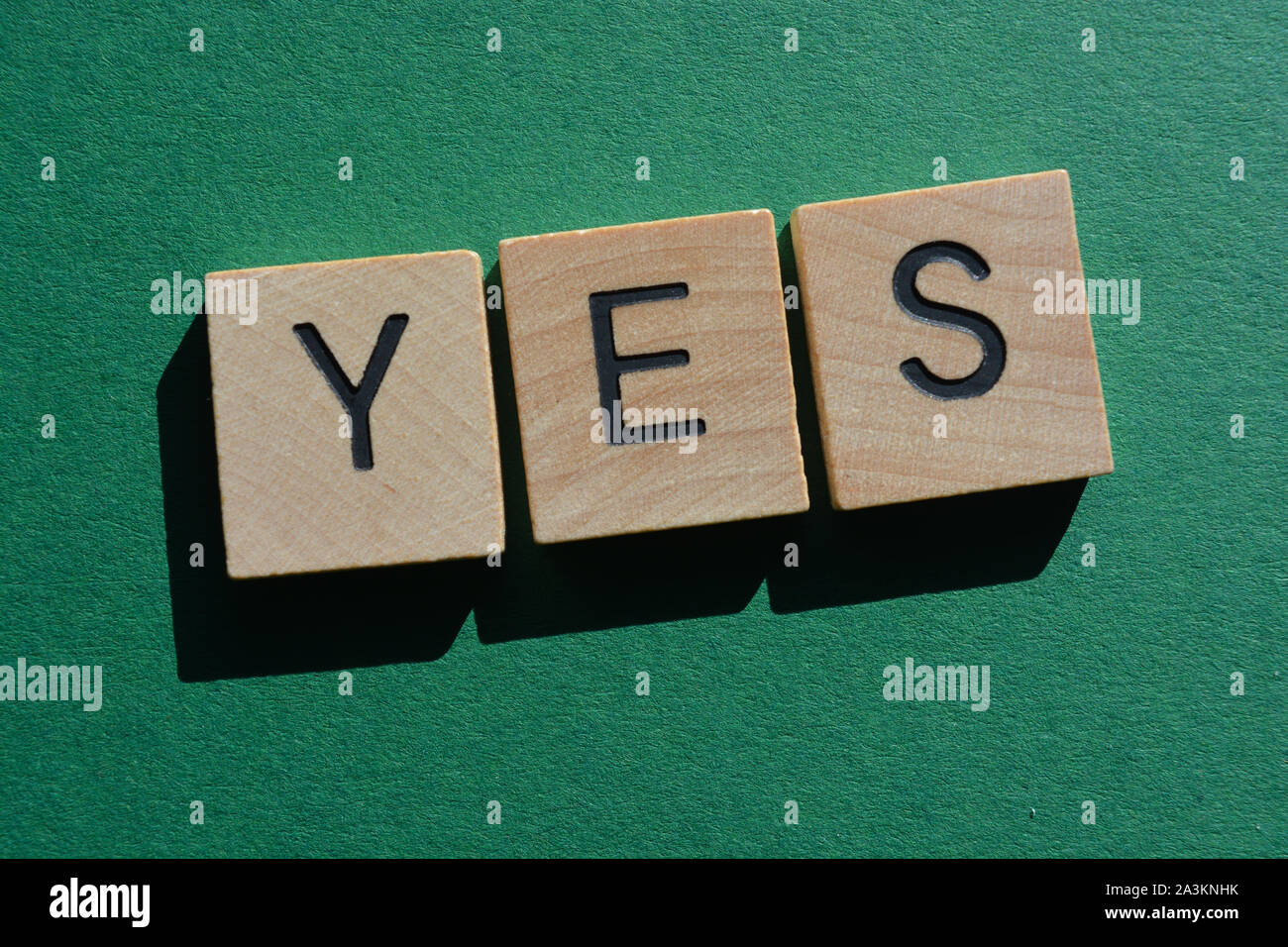 Yes in 3d wooden alphabet letters isolated on a green background Stock ...