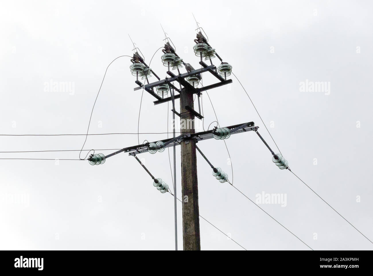 Electricity pole and wired with grey sky background Stock Photo - Alamy