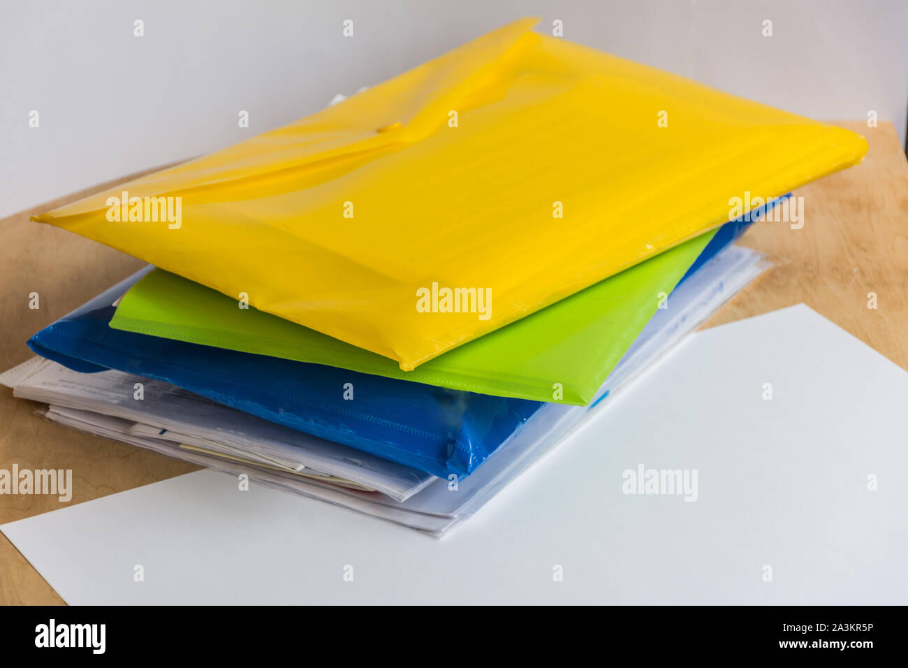 Stack of colorful data folders on the office wooden table. Office ...