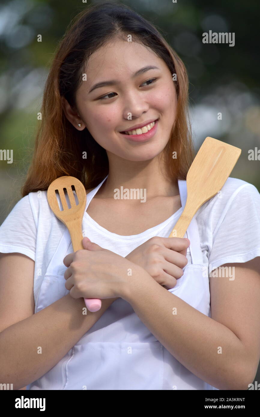 Smiling Diverse Female Cook With Utensils Stock Photo - Alamy