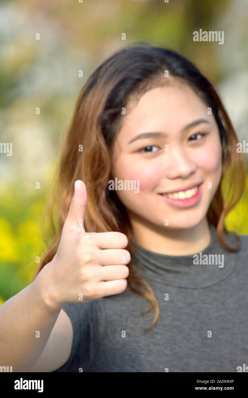 Pretty Diverse Adult Female With Thumbs Up Stock Photo - Alamy