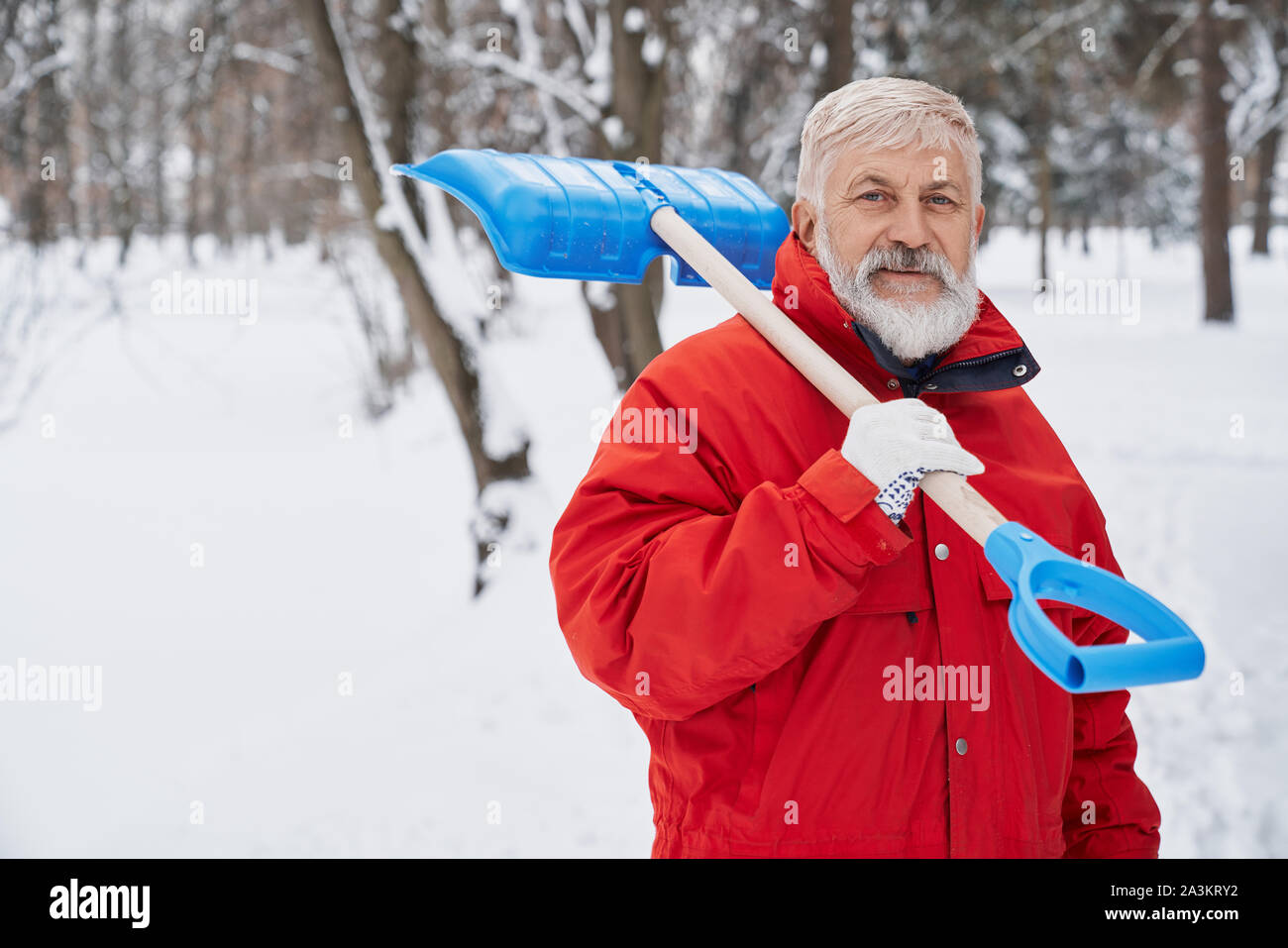 Front view of man looking at camera and smiling while cleaning park ...