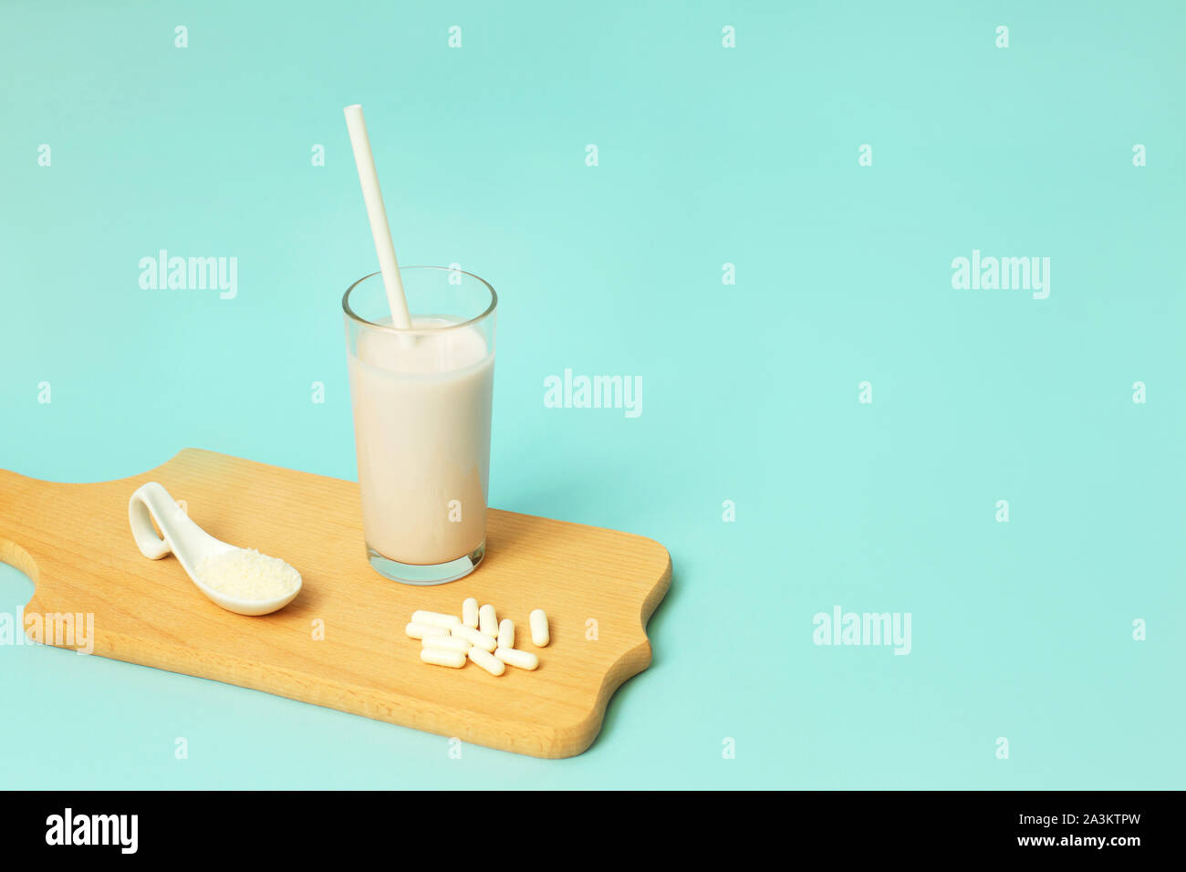 Collagen powder, milk and pills on blue background. Extra protein ...