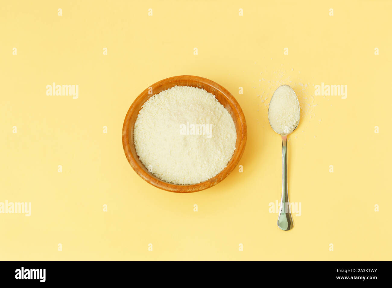 Collagen protein in the bowl and spoon - Hydrolyzed on yellow ...