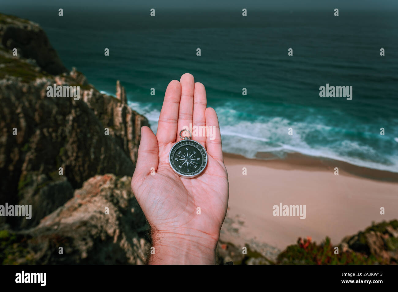 Looking at the compass in man hand palm symbolling adventure-seeking ...