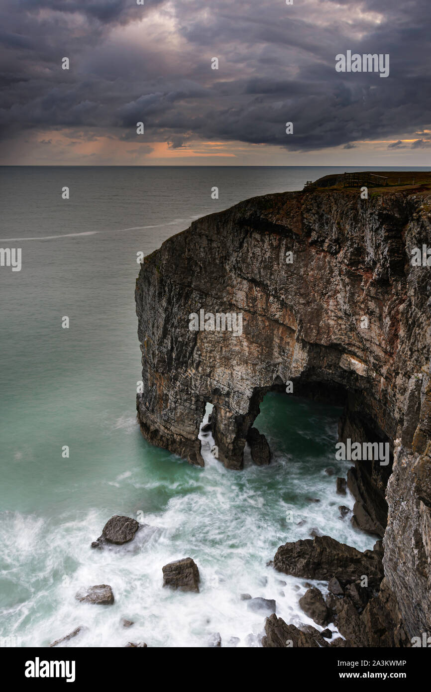 Sunset over Green Bridge of Wales, famous, natural rock arch, popular ...