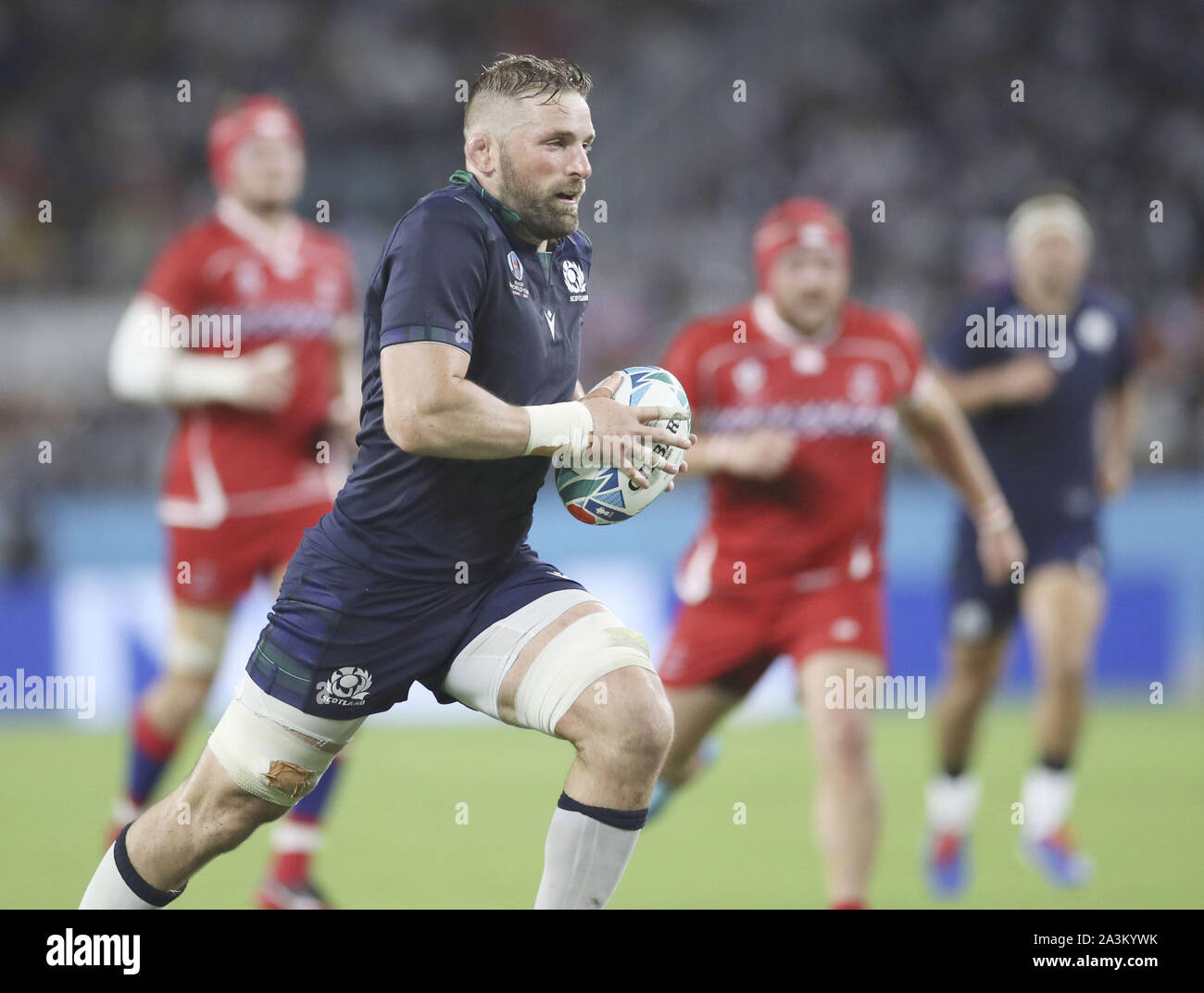 John Barclay of Scotland runs with the ball on his way to scoring a try ...