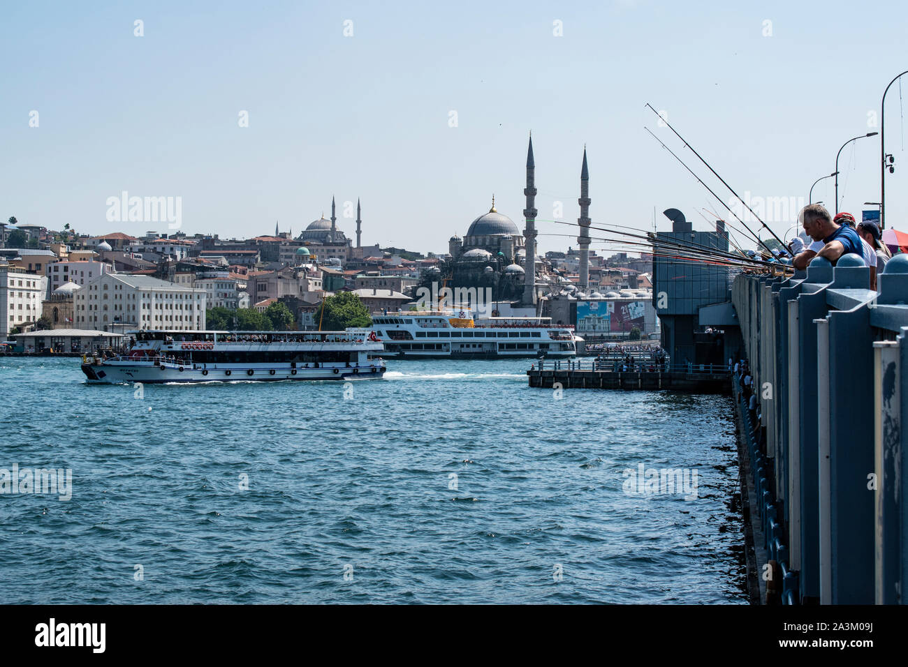 Istanbul: skyline of the city and local fishermen with their fishing ...