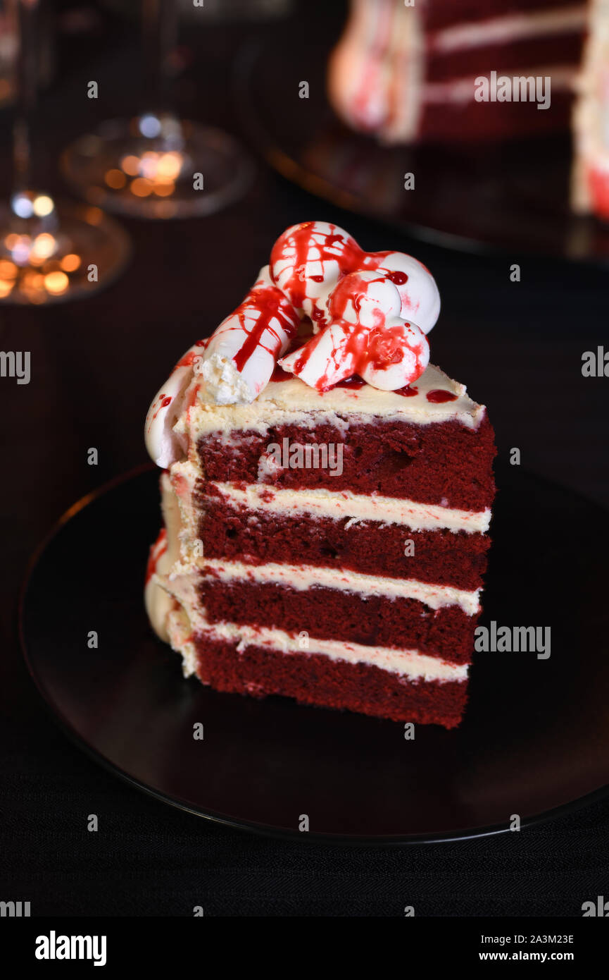 A piece of creepy cake (red velvet), decorated with meringue bones and ...