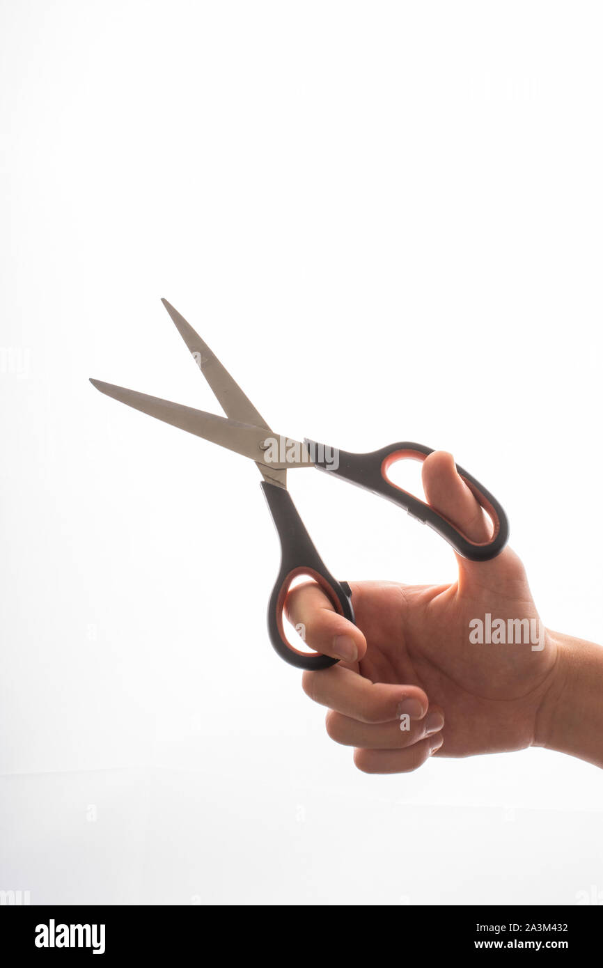 Hand holding steel scissors on a white backgruond Stock Photo - Alamy