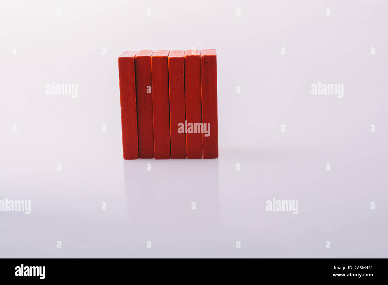 Red color domino blocks placed on a white background Stock Photo - Alamy