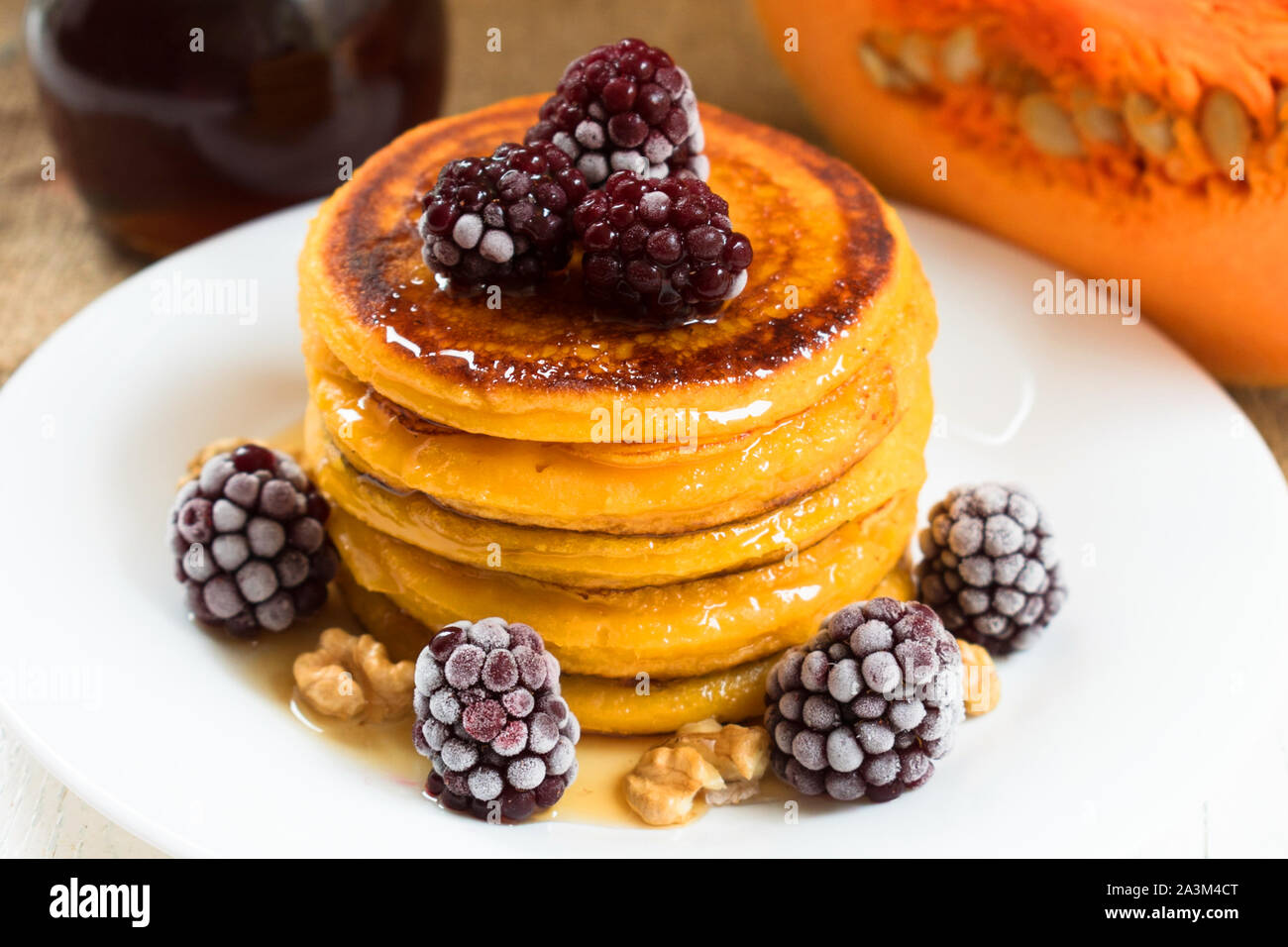 Pumpkin pancakes with maple syrup, berries and nuts. End of seasonal ...