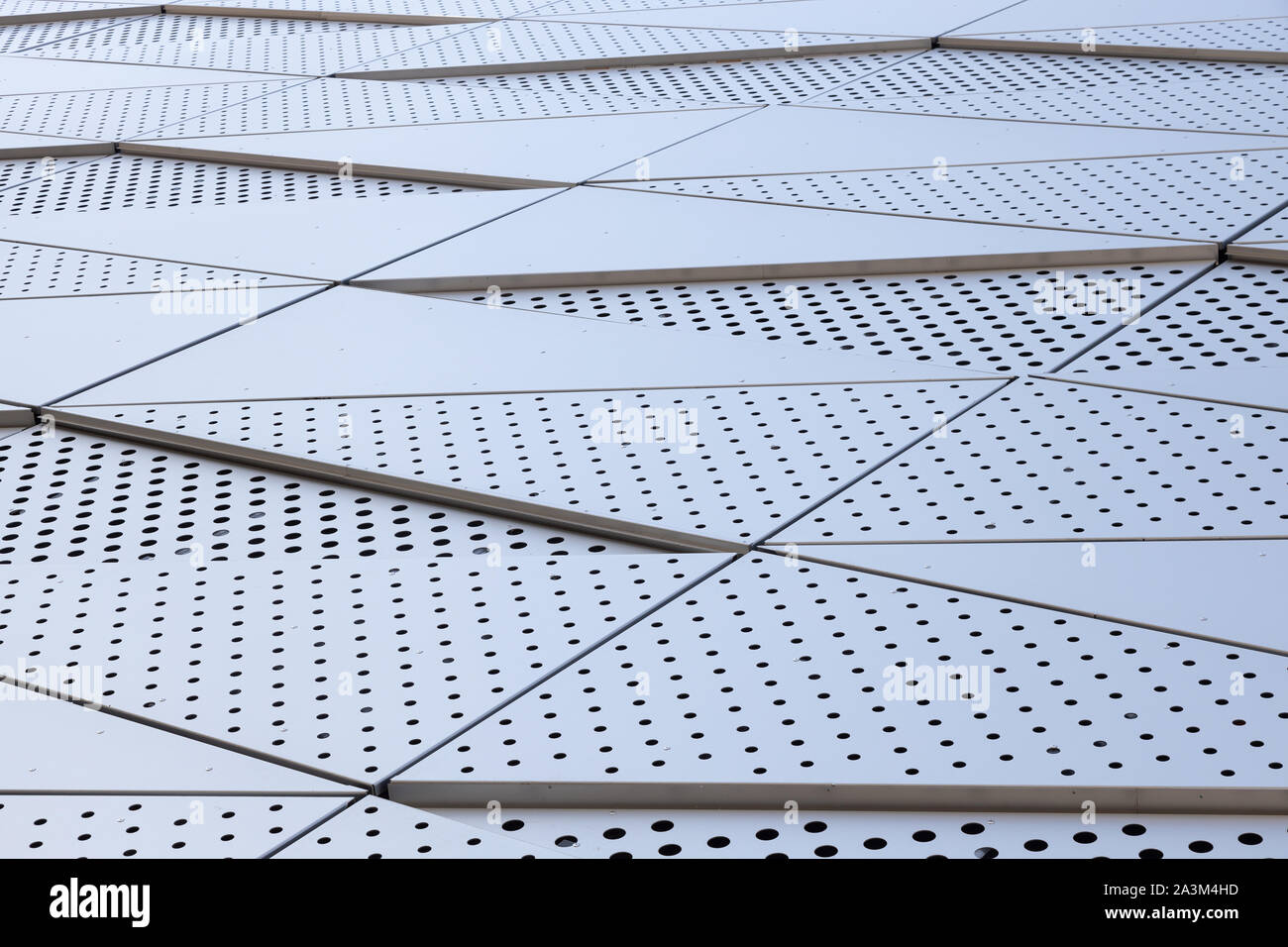 Wide angle view of building wall with triangular pattern and round ...