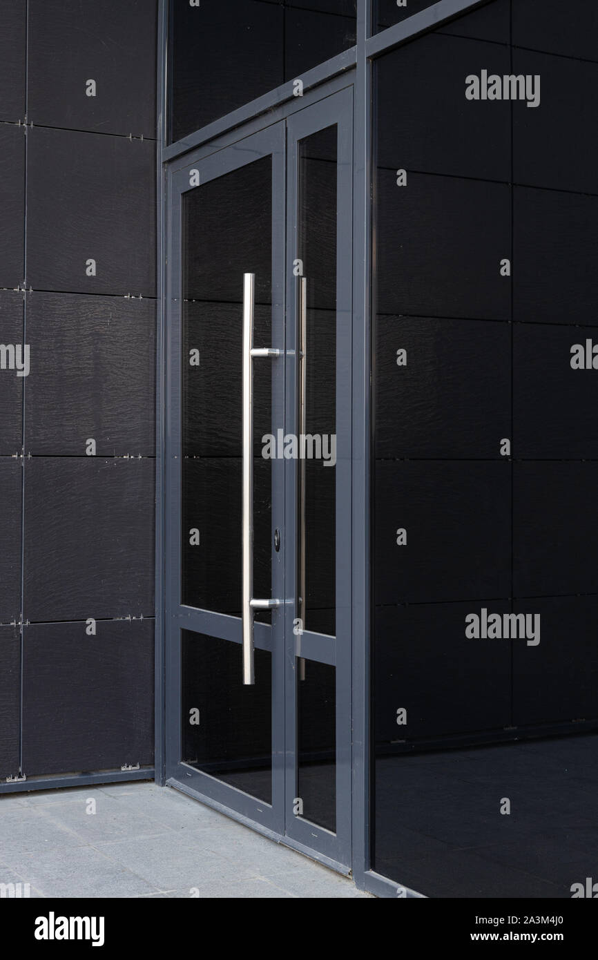 Side-view of glass door - entrance to modern office building Stock ...