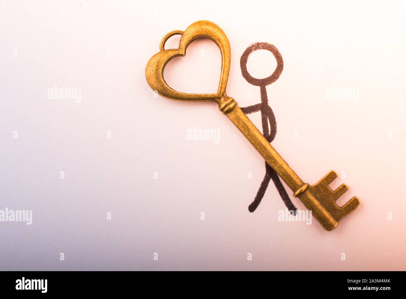 Man carrying a heart shaped key on white background Stock Photo - Alamy