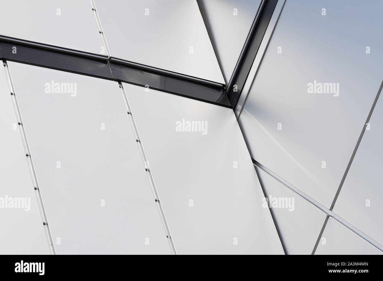 Close-up of inner corner of building with smooth white walls with black ...