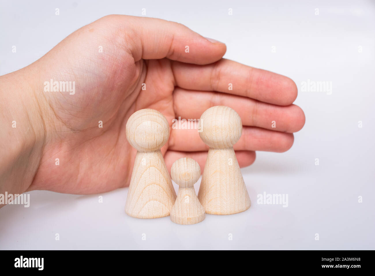 Wooden figurines of family as concept of caring for children Stock ...