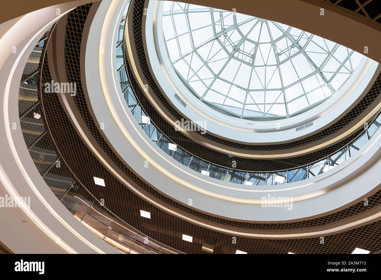 Ground view of modern high building round vintage ceiling at shopping ...