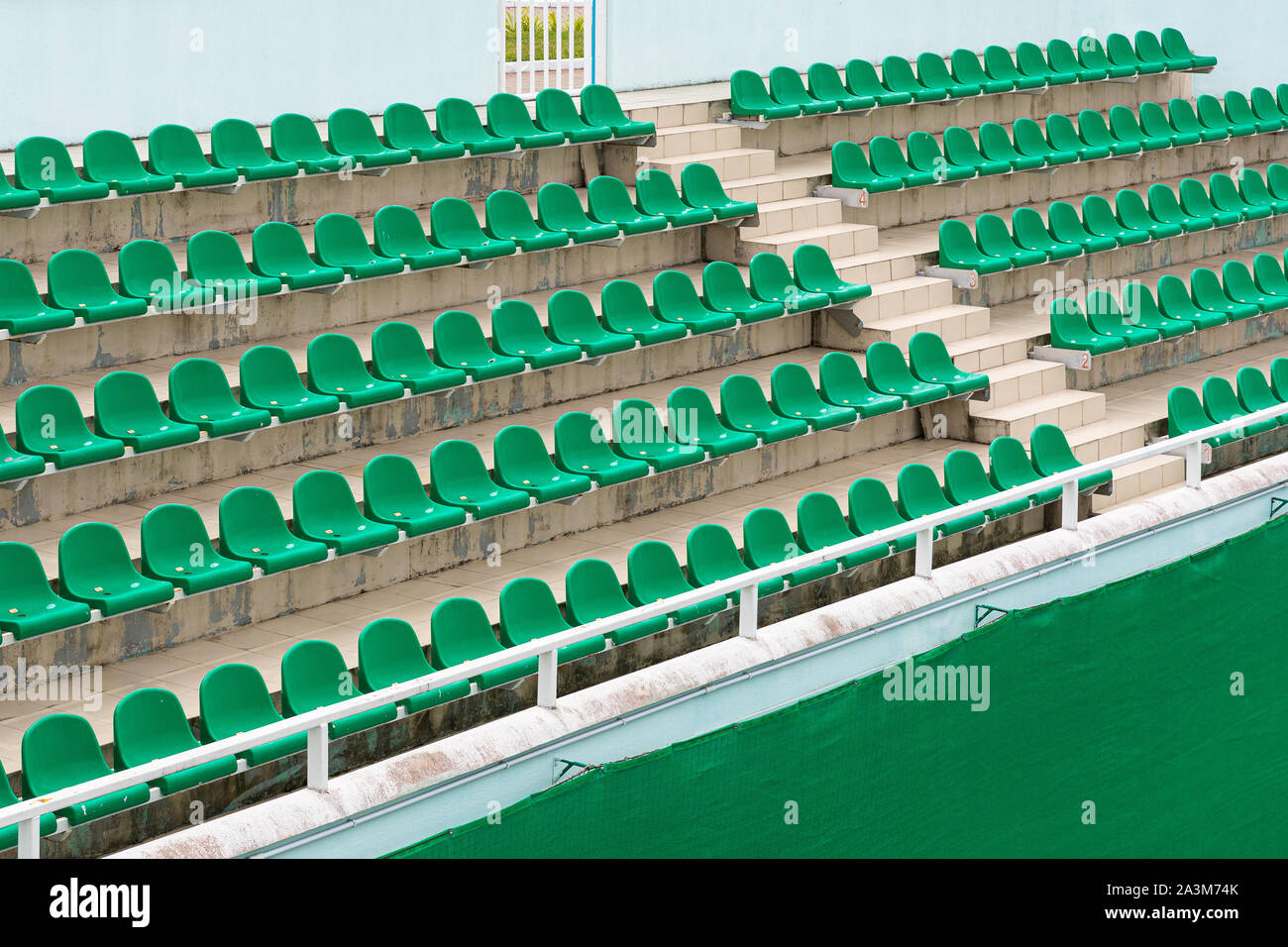 Rows of green spectator seats at sport facility with nobody, diagonal ...