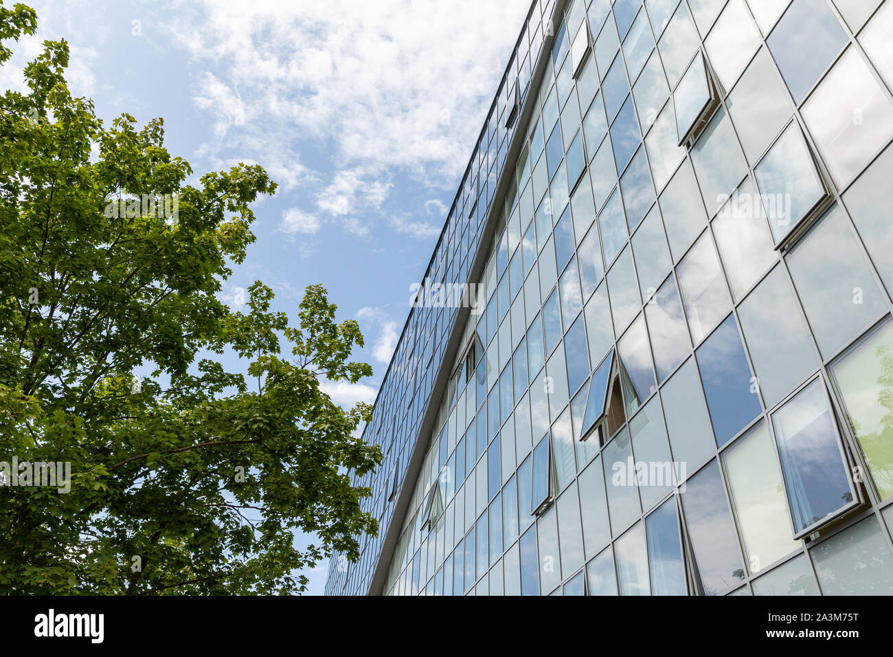 Modern building with glass reflecting facade co-existing with sky ...