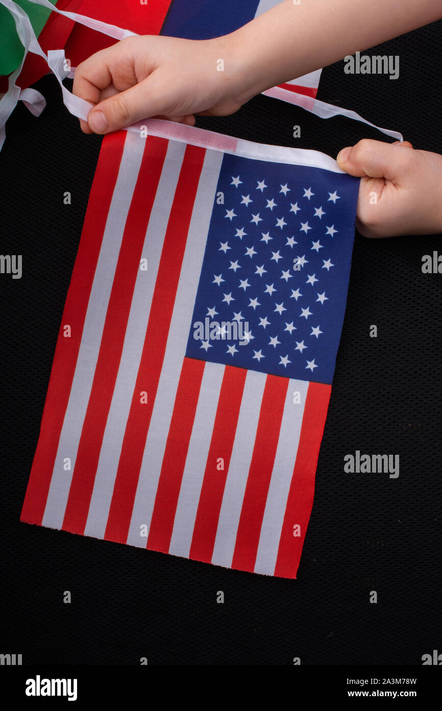 Child hand holding an American national flag in hand Stock Photo - Alamy