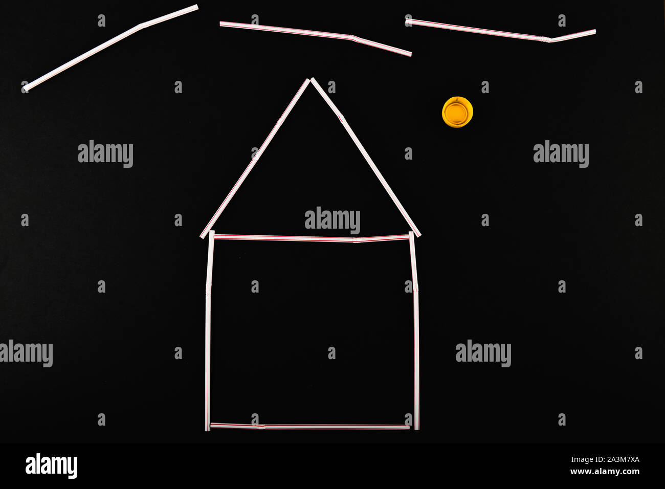 plastic house. Plastic model of the house. On a black background. Real ...