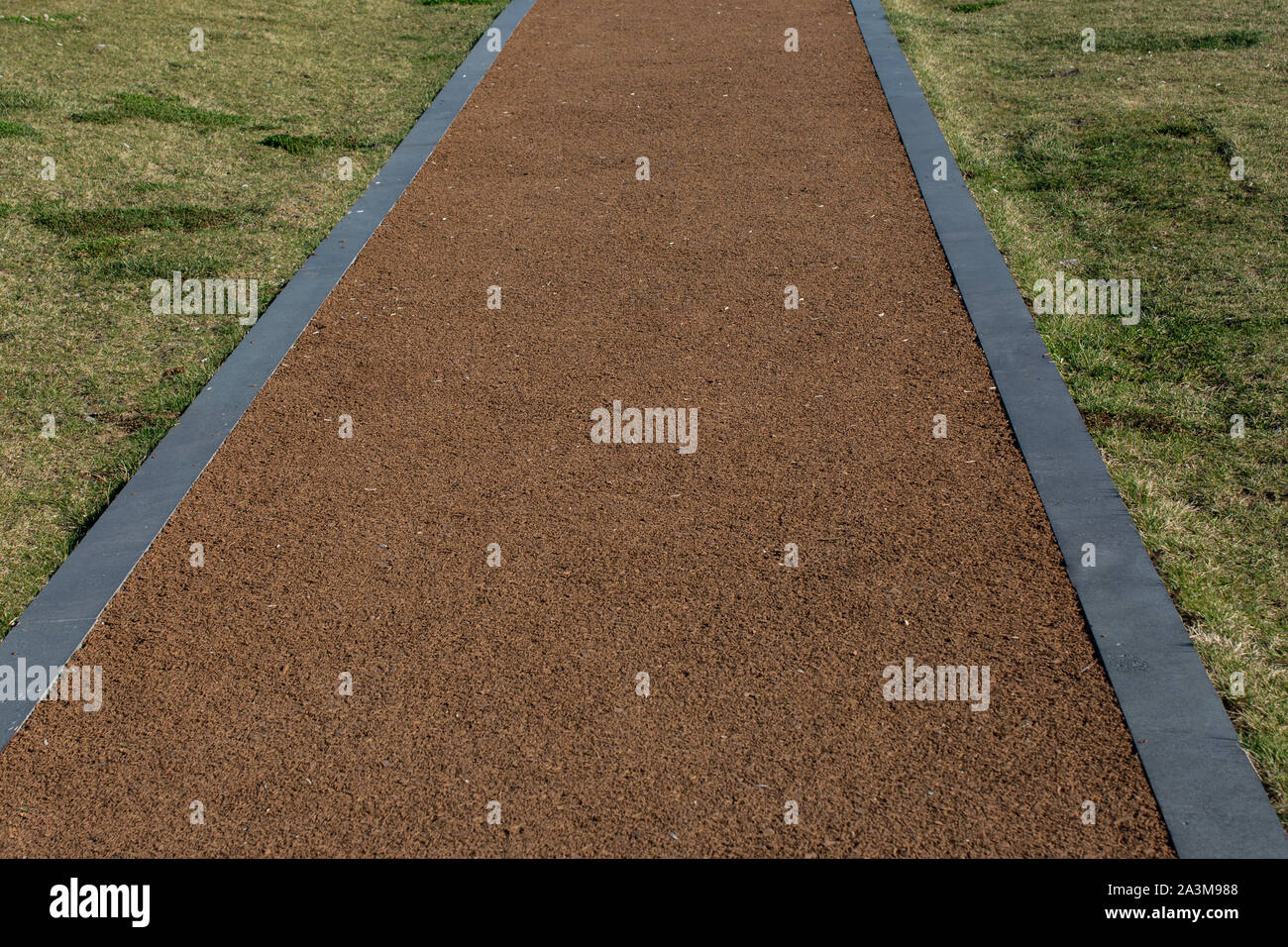 Rubber running path in a park in view Stock Photo - Alamy