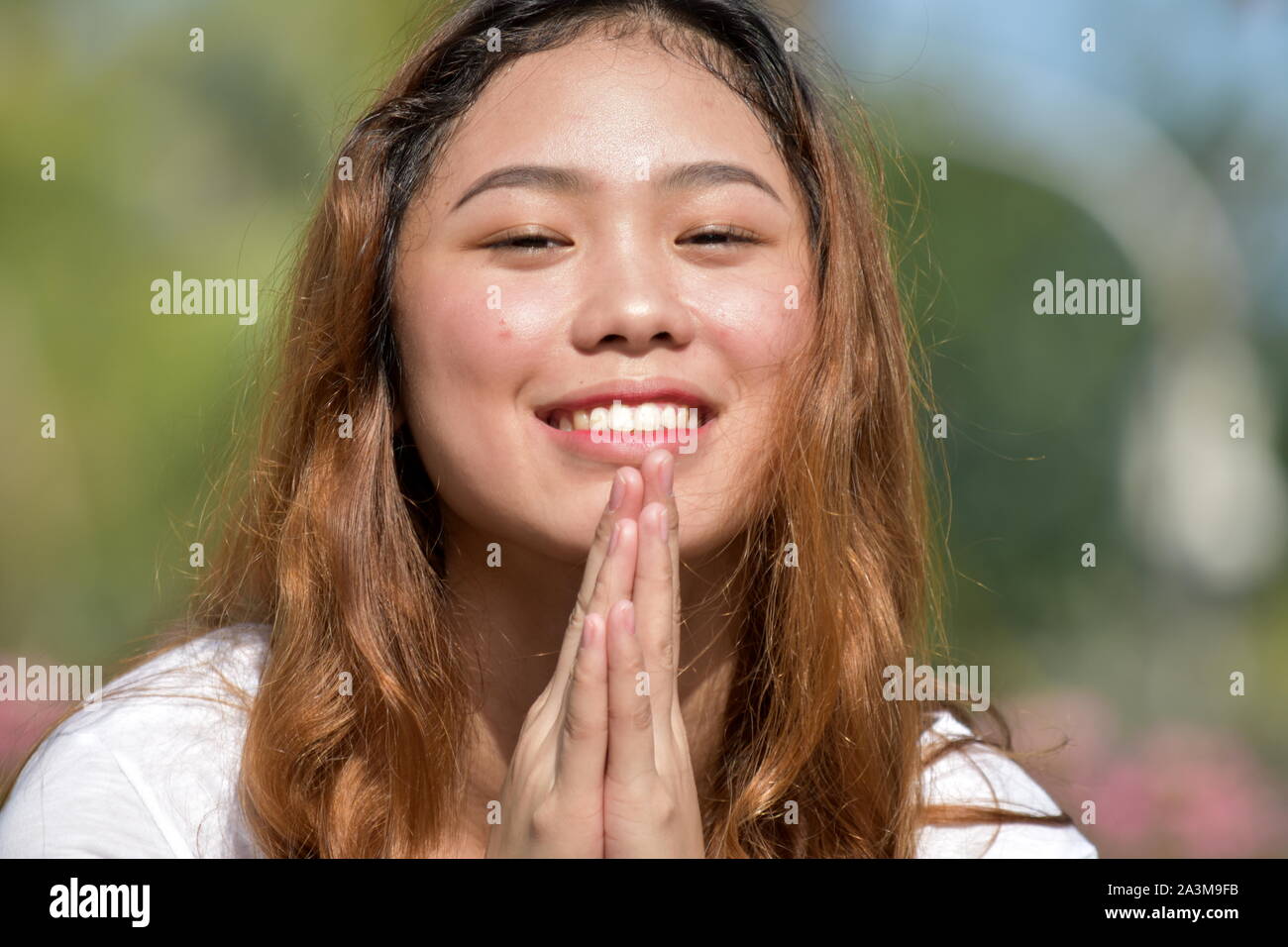 An Asian Female Praying Stock Photo - Alamy