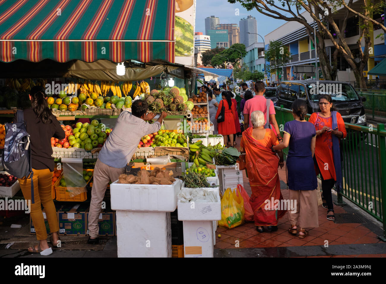 Market stalls with colorful fruits and vegetables, and mostly ethnic ...