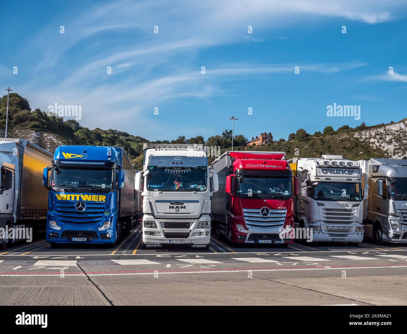 Heavy goods lorries parked at port of Dover transport terminal waiting ...