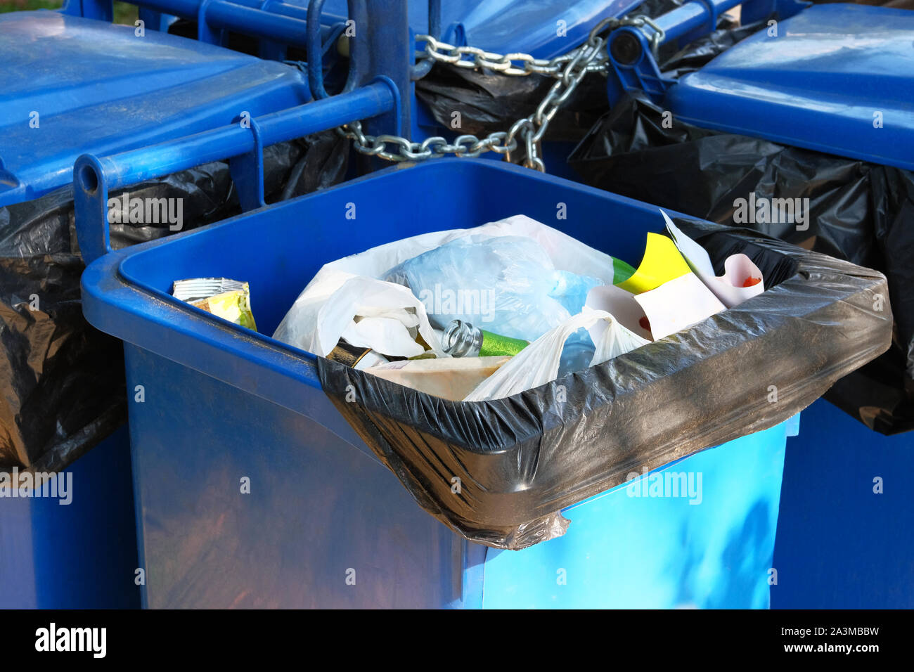 Dumpsters blue being full with garbage. Garbage is pile lots dump ...