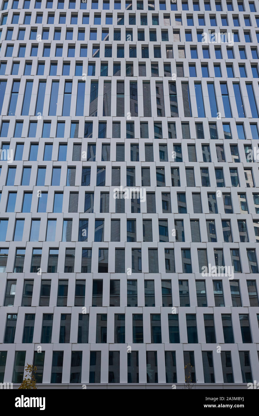 Closeup of the glass front of a skyscraper, which reflects an opposite ...
