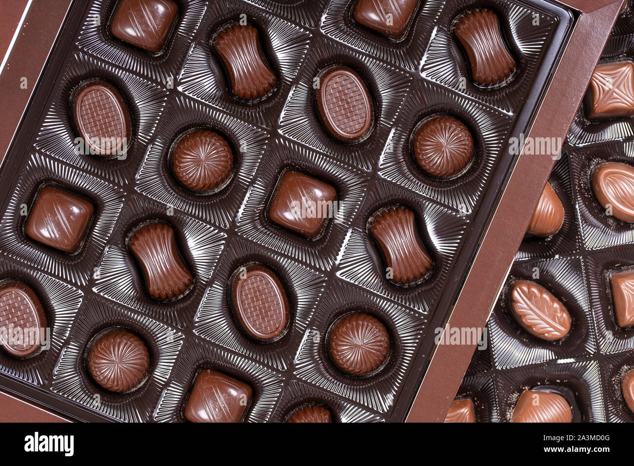 Close up brown chocolate candy background. Assortment of chocolate ...