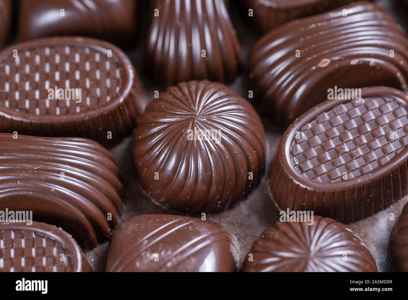 Close up brown chocolate candy background. Assortment of chocolate ...