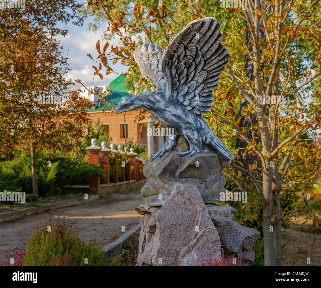 barn eagle statue in the fall on a warm day, against a background of ...