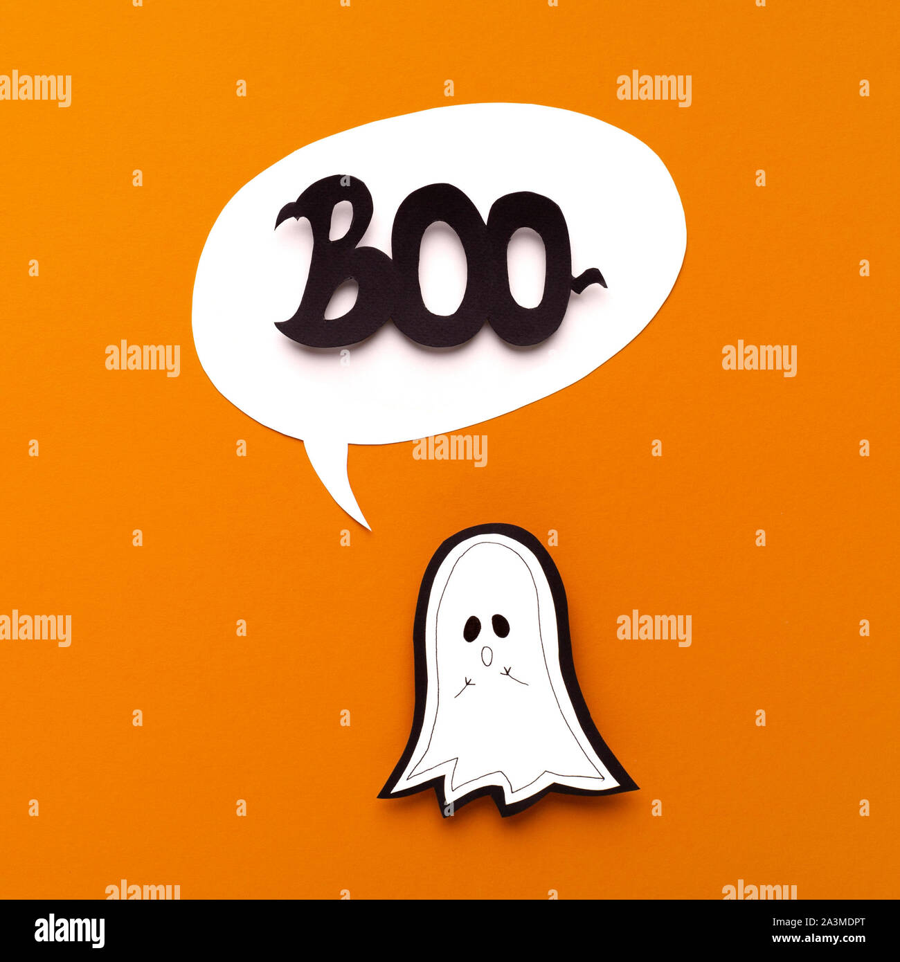 Scary ghost saying boo on orange Halloween background Stock Photo - Alamy