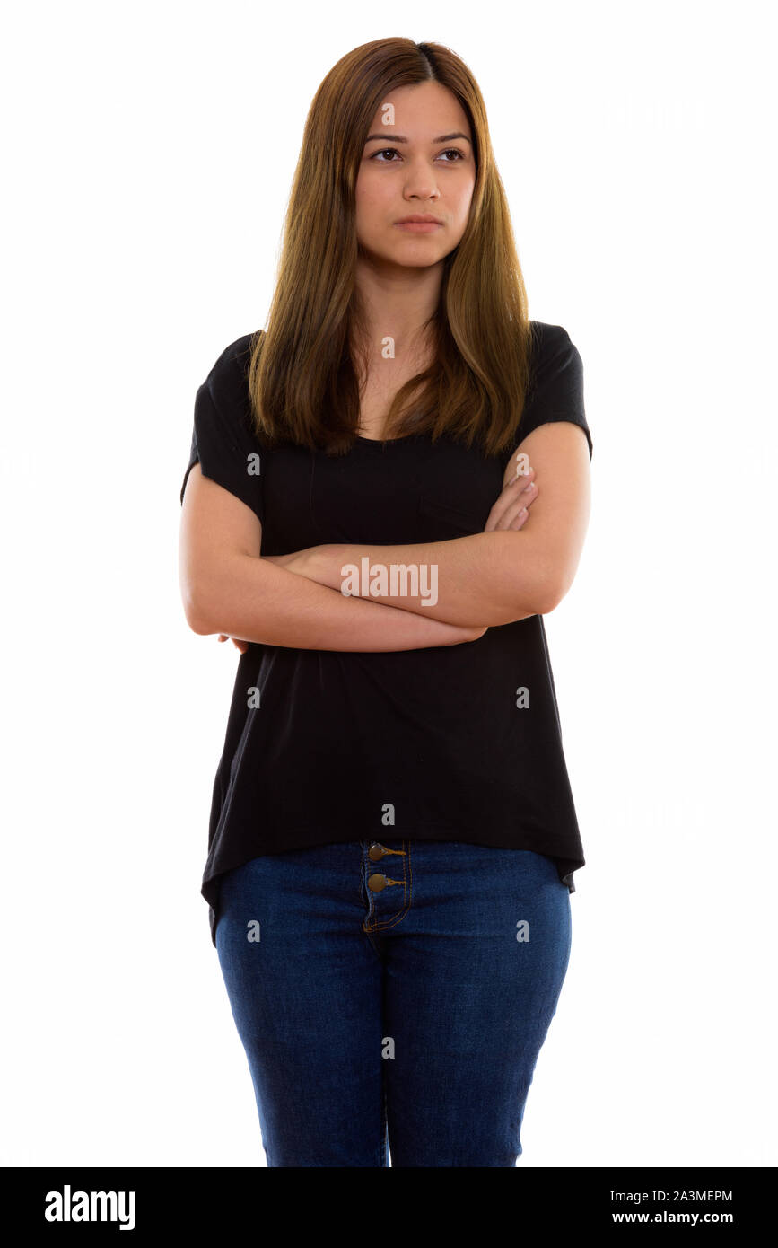 Studio shot of young beautiful woman standing and thinking with Stock ...