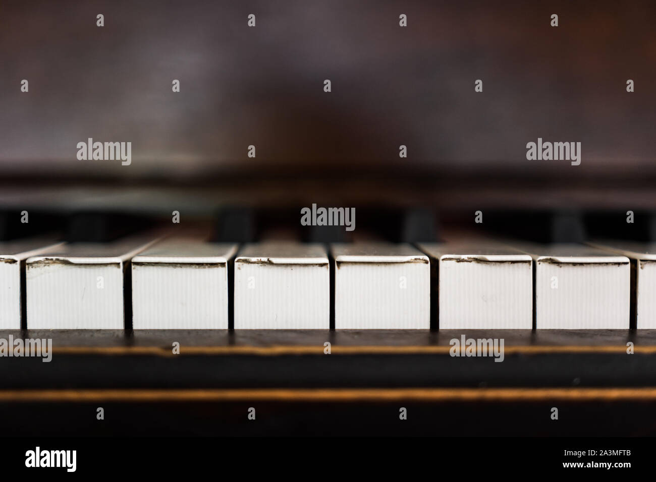 Grungy beat up piano keys of old player piano Stock Photo - Alamy