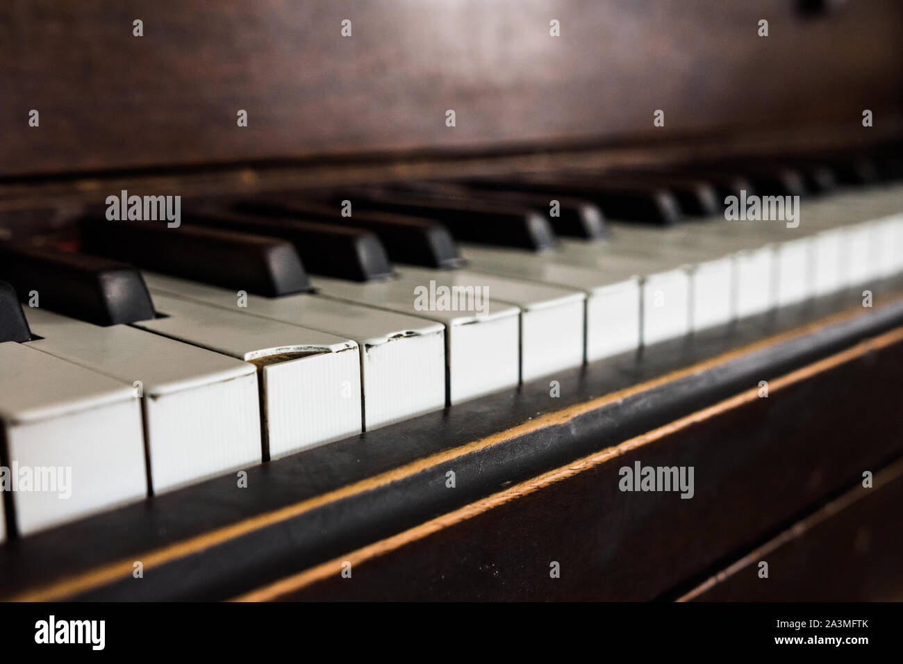 Grungy beat up piano keys of old player piano Stock Photo - Alamy