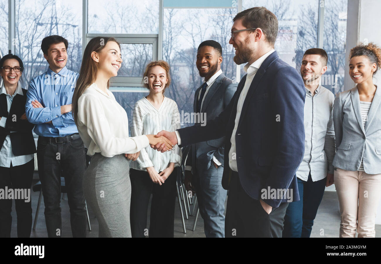 Welcome! Boss and woman shaking hands in office Stock Photo - Alamy