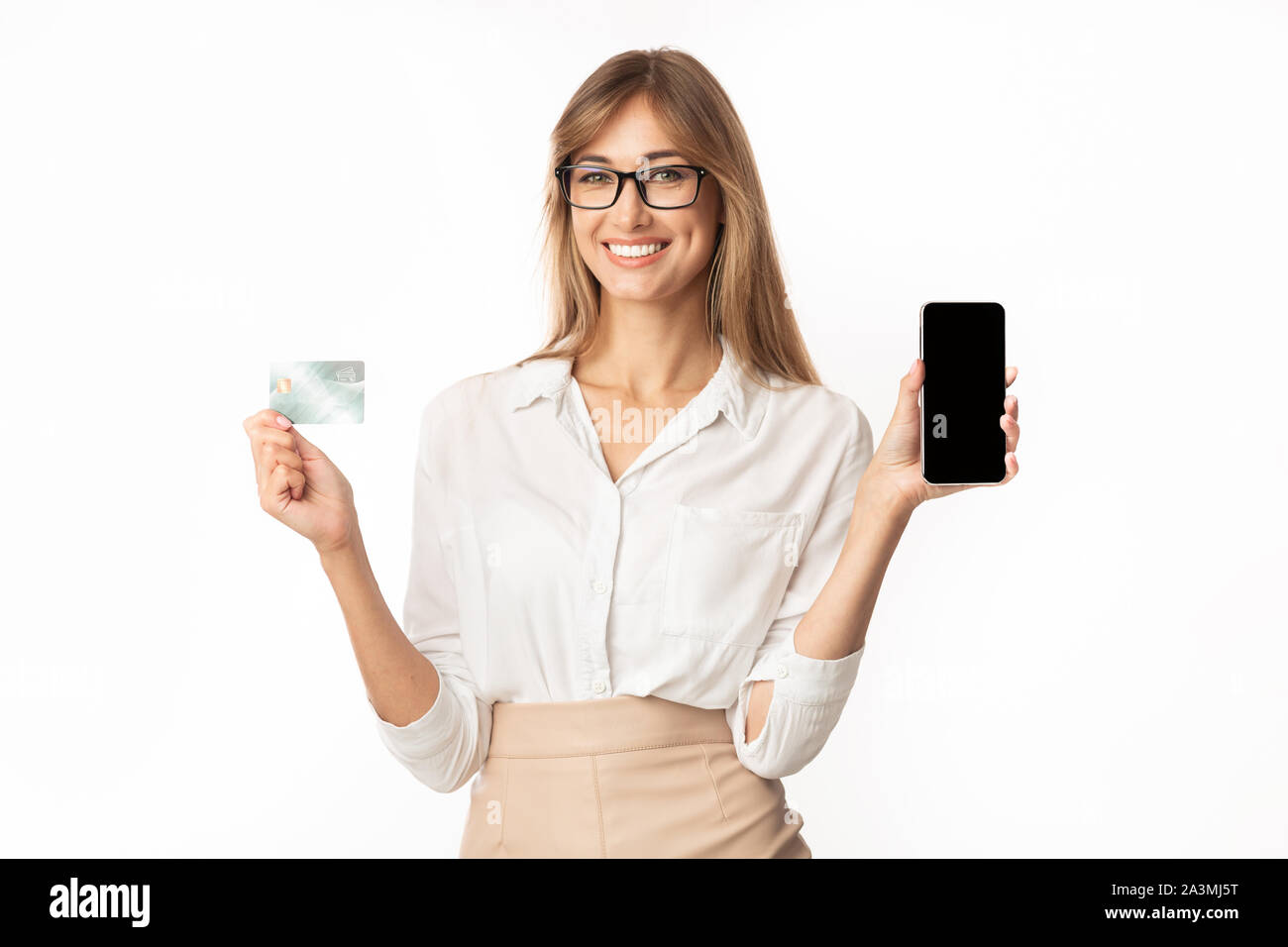 Smiling Woman Holding Cellphone And Credit Card Over White Background ... Smiling Woman Holding Cellphone And Credit Card Over White Background ...